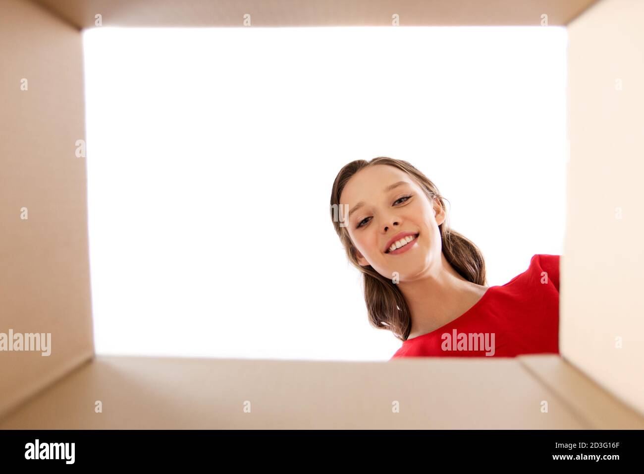happy young woman looking into open gift box Stock Photo - Alamy
