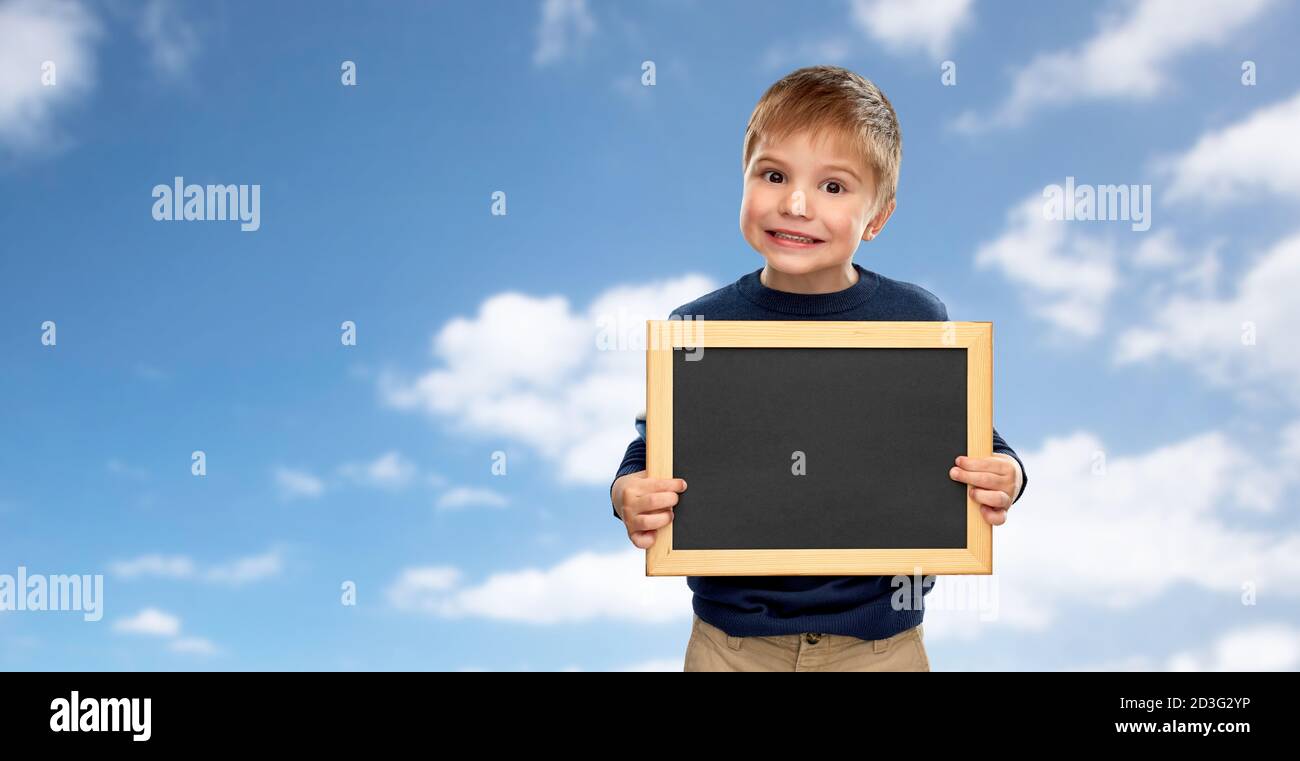 little boy with black blank chalkboard over sky Stock Photo - Alamy
