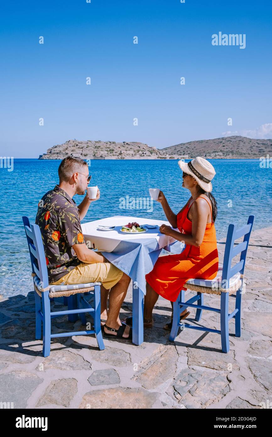 Plaka Lassithi with is traditional blue table and chairs and the beach ...