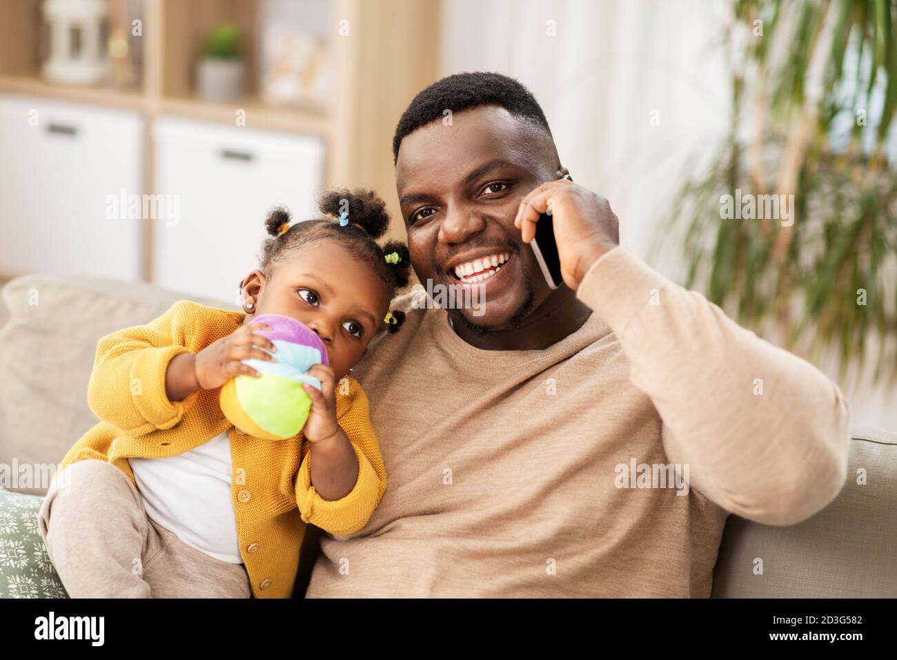 father with baby at home calling on smartphone Stock Photo - Alamy