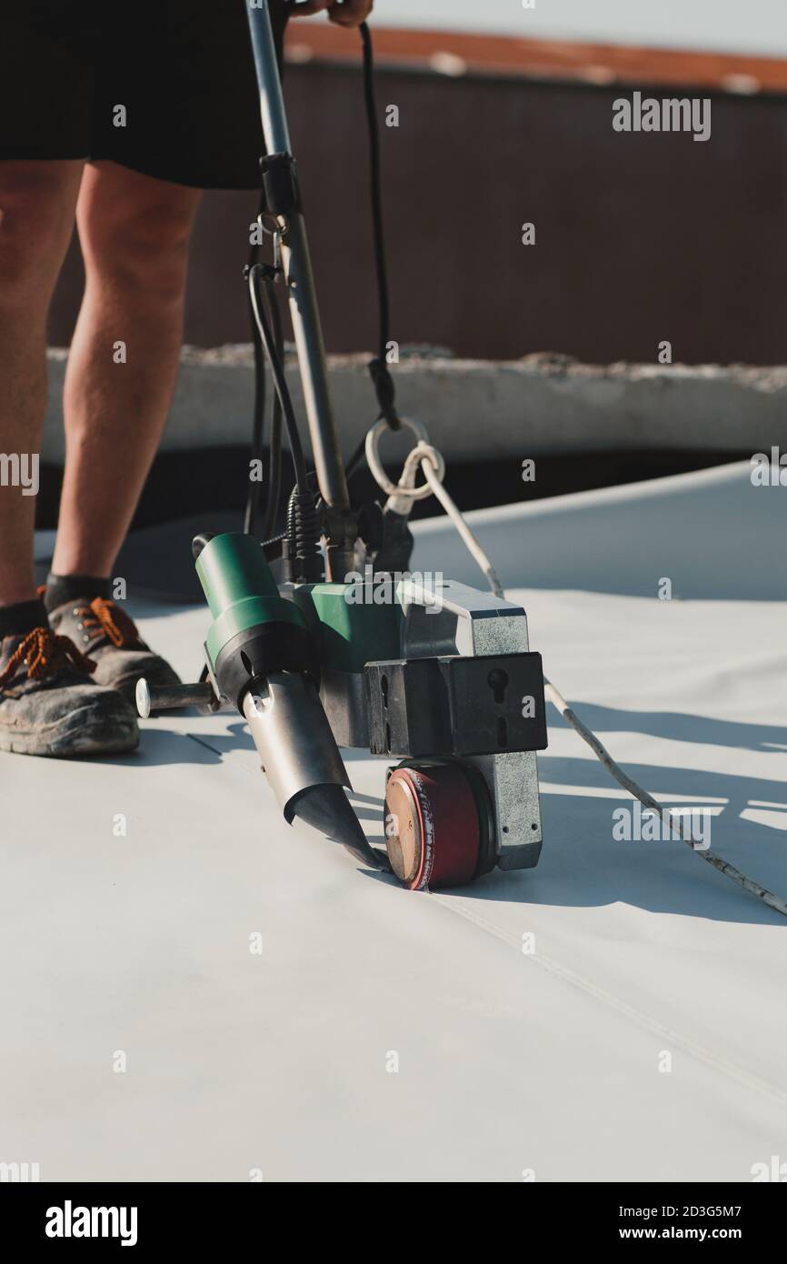 Worker welding pvc roof membrane by heater with welder machine Stock ...
