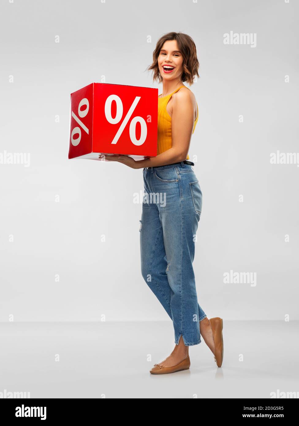 happy smiling young woman with sale sign Stock Photo - Alamy