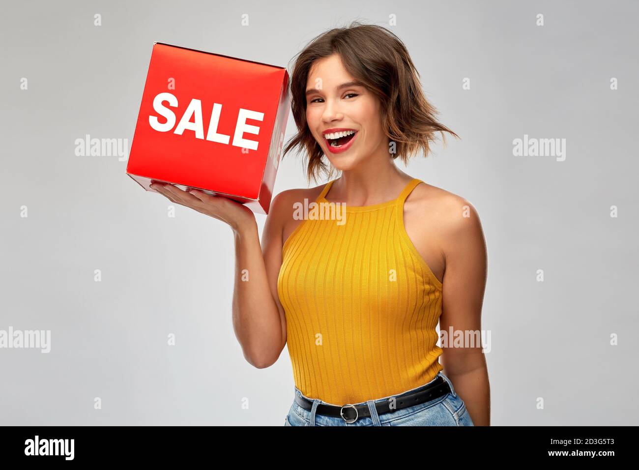 happy smiling young woman posing with sale sign Stock Photo - Alamy
