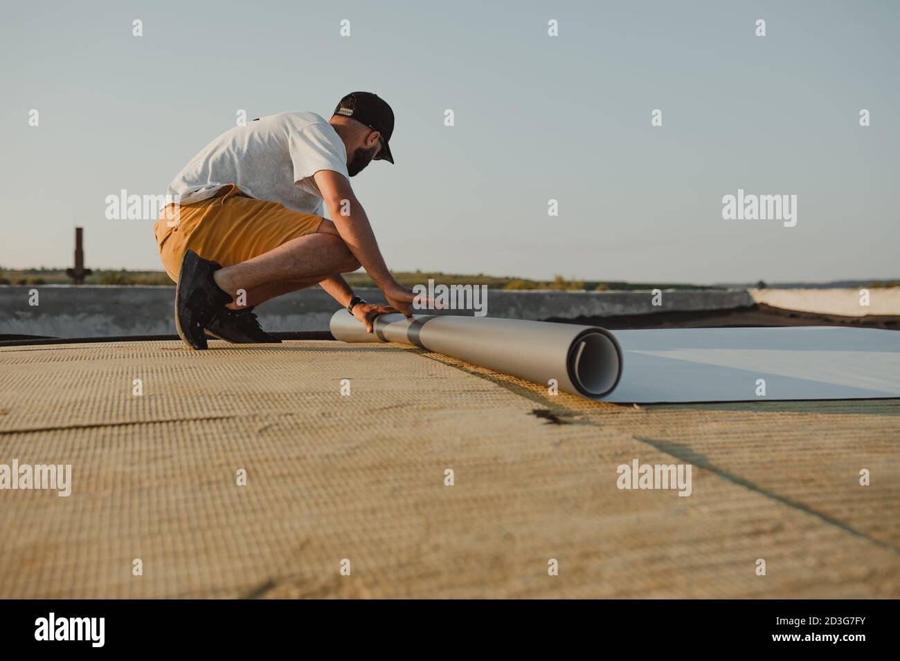 Worker applies pvc membrane roller on roof very carefully Stock Photo ...