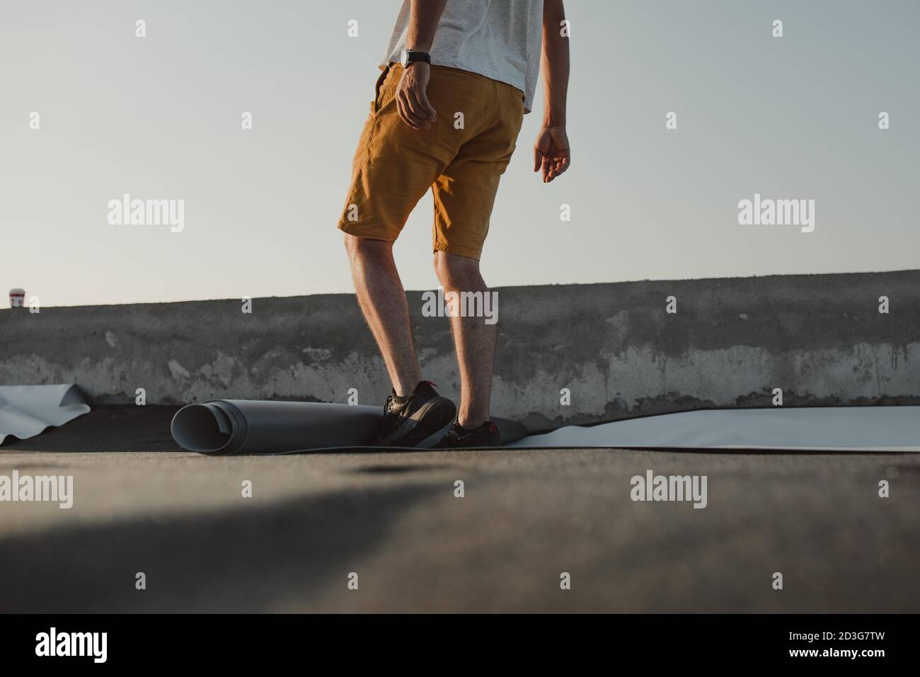 Worker applies pvc membrane roller on roof very carefully Stock Photo ...