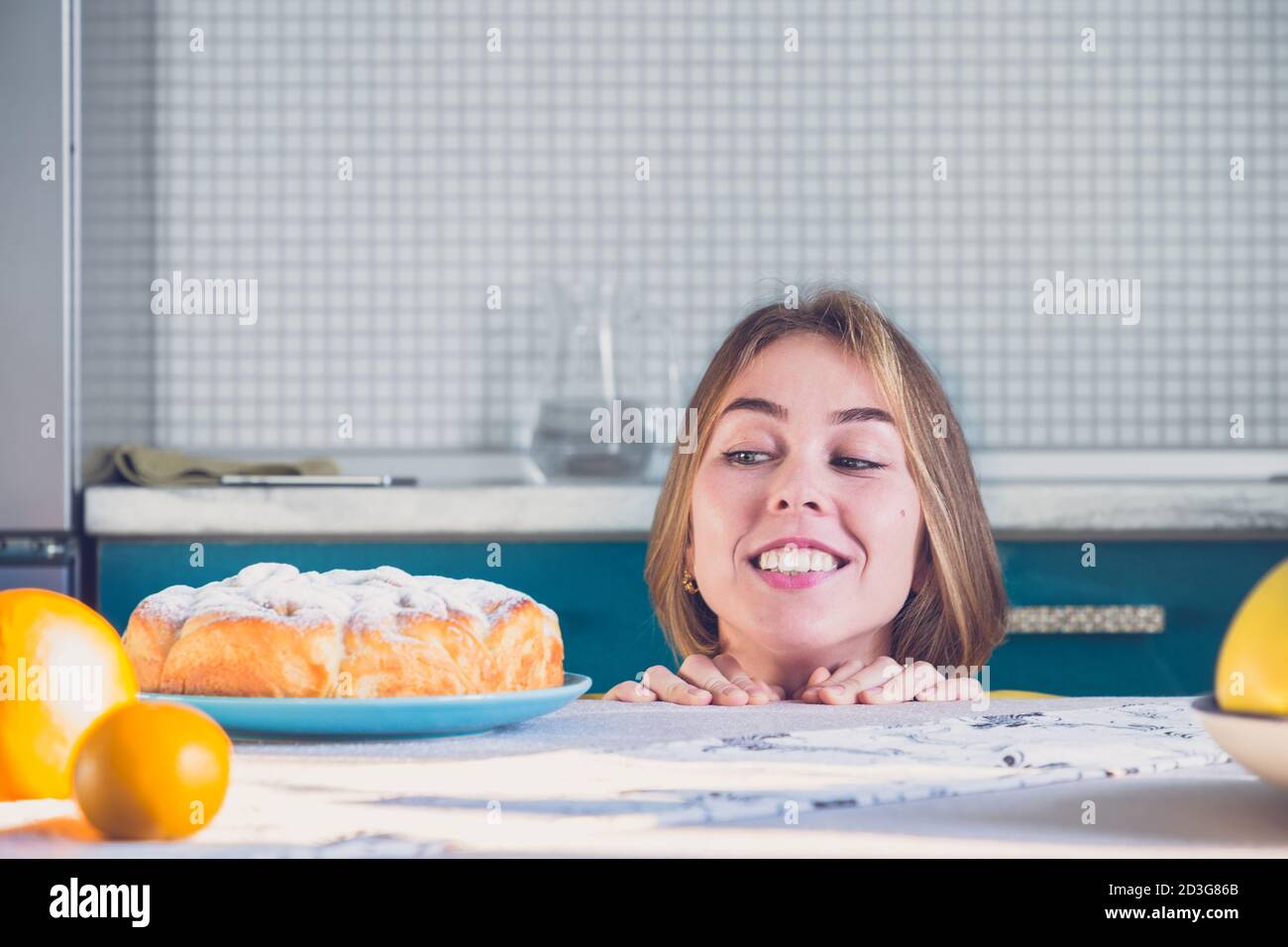 Smiling girl look at the fresh pie and want to try a piece of it. Diet ...