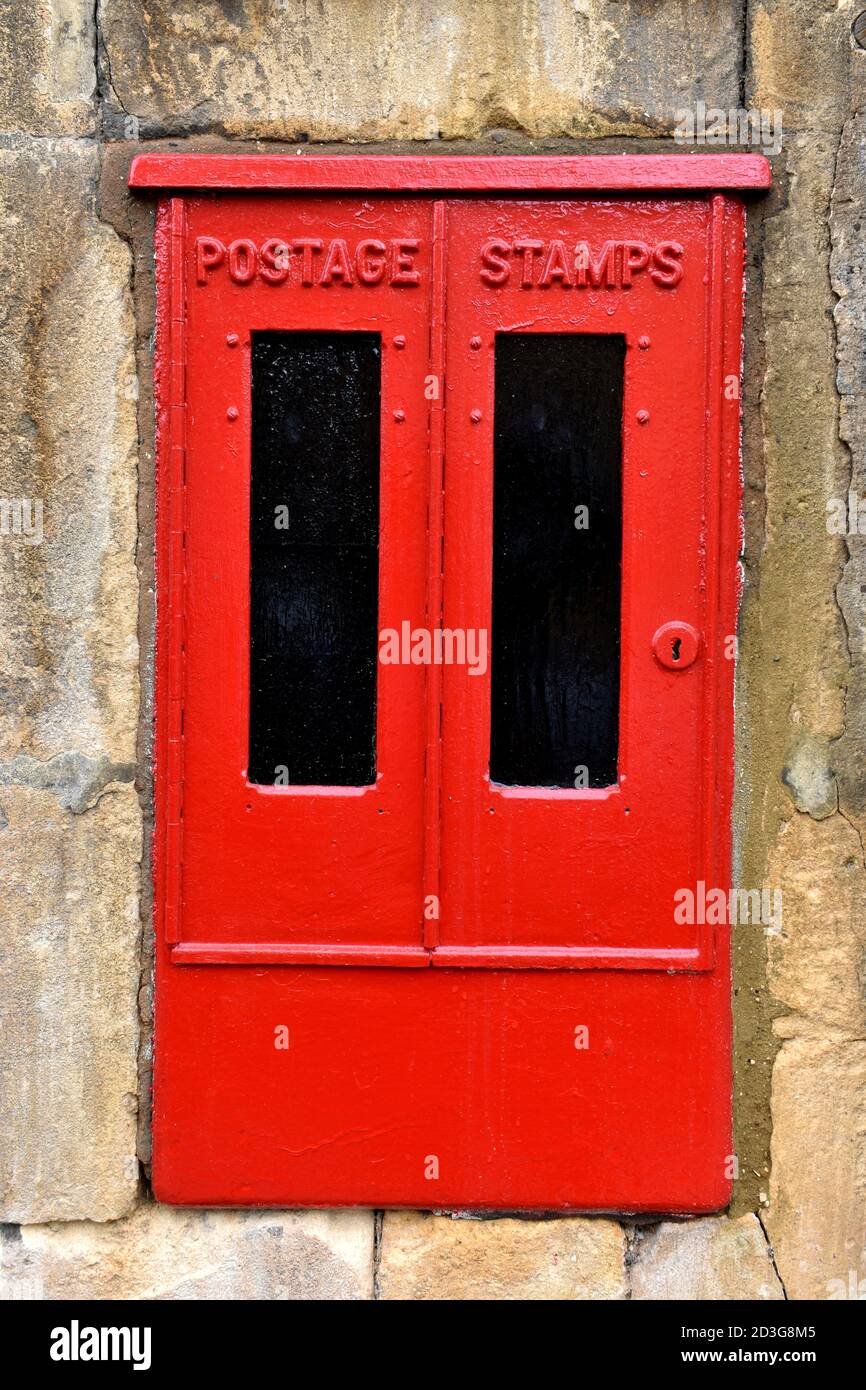 close up of old metal, red painted postage stamp box with black panels ...