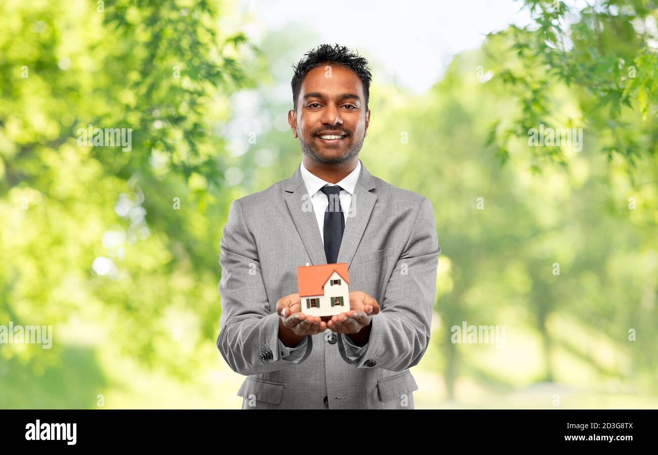 man realtor with house model and folder Stock Photo - Alamy