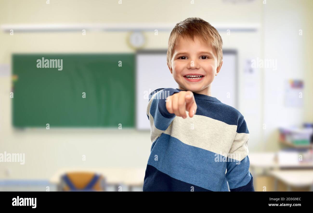 little boy pointing finger at school Stock Photo - Alamy