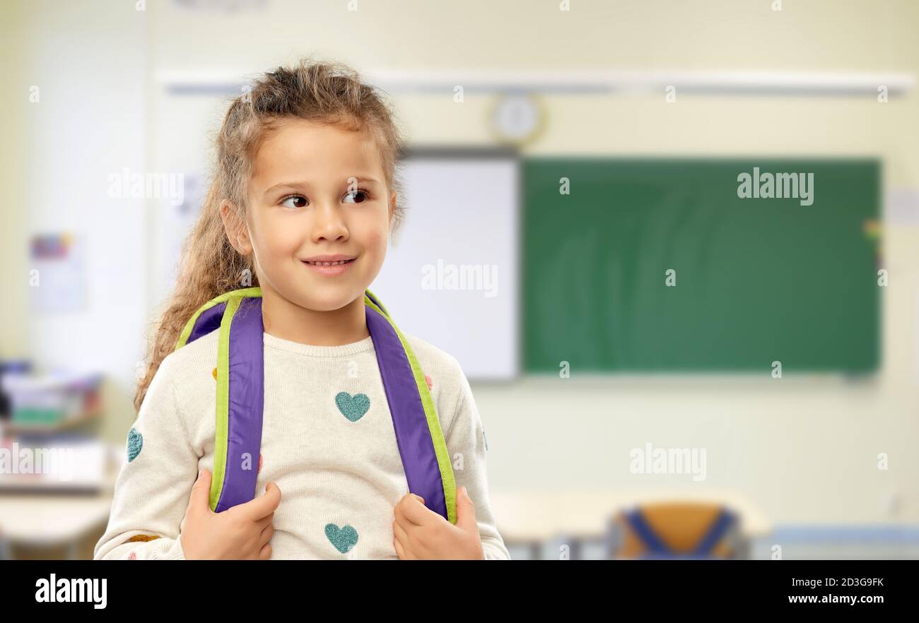 happy little girl with backpack at school Stock Photo - Alamy