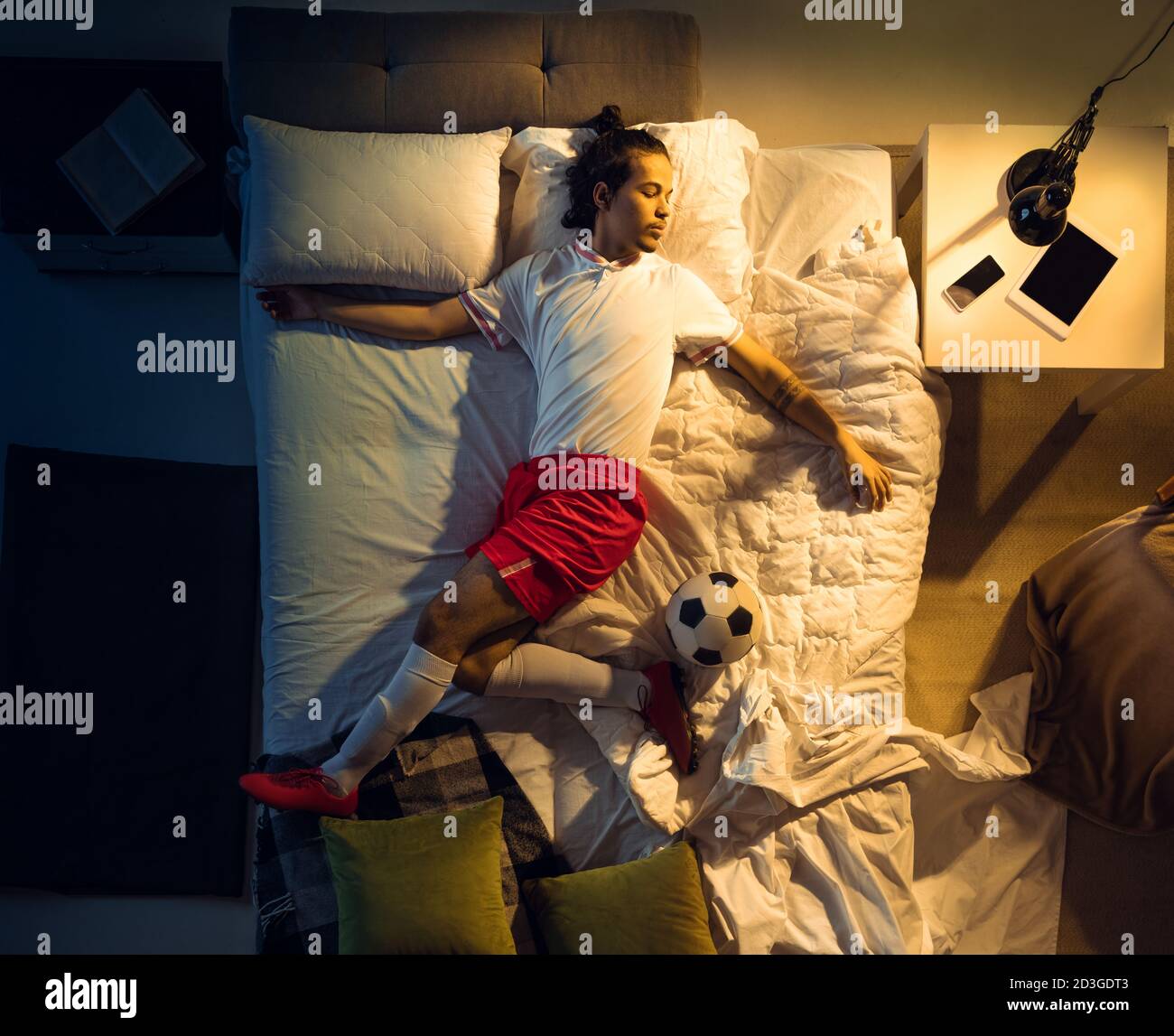 Kicking. Top view of young professional football, soccer player ...