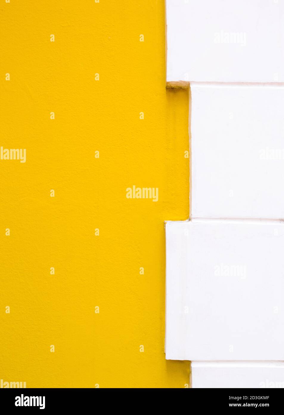 Yellow painted wall with the white brick border of the church wall in ...