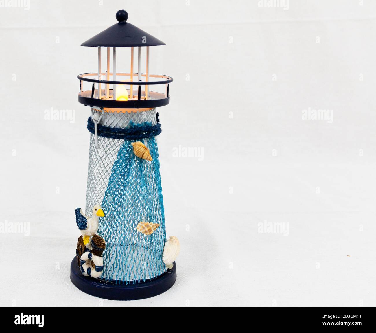 A small blue and white to lighthouse used as a table decoration with ...
