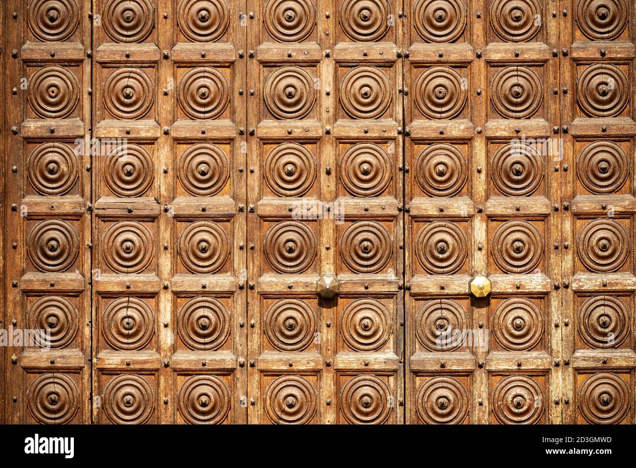 Closeup of an ancient studded wooden door with square and circle shapes ...