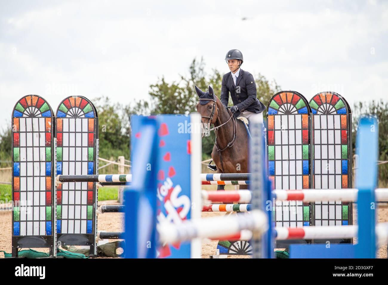 Horse riders competing in a showjumping competition Stock Photo - Alamy