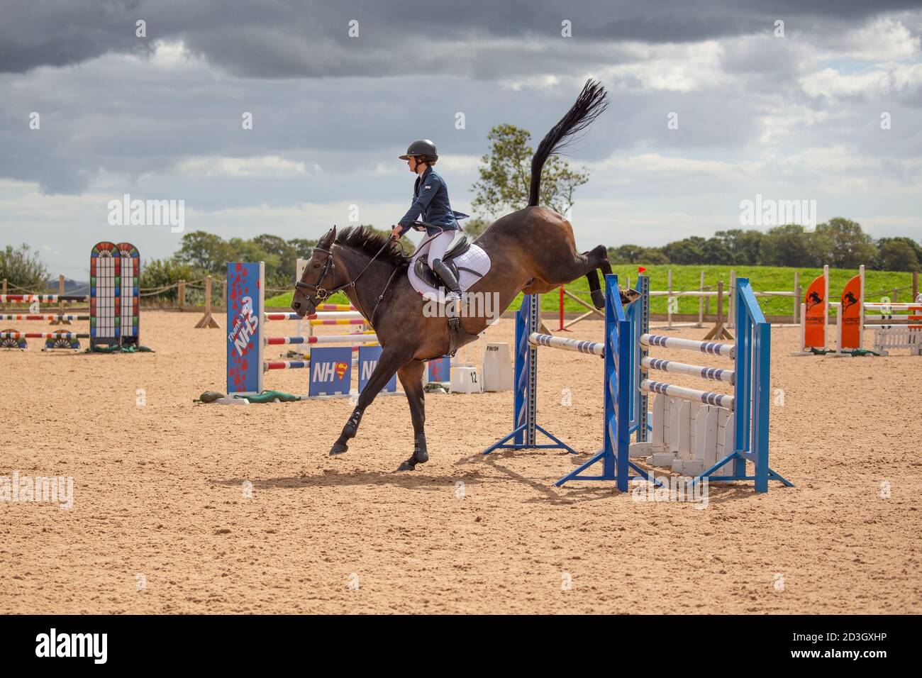 Horse riders competing in a showjumping competition Stock Photo - Alamy