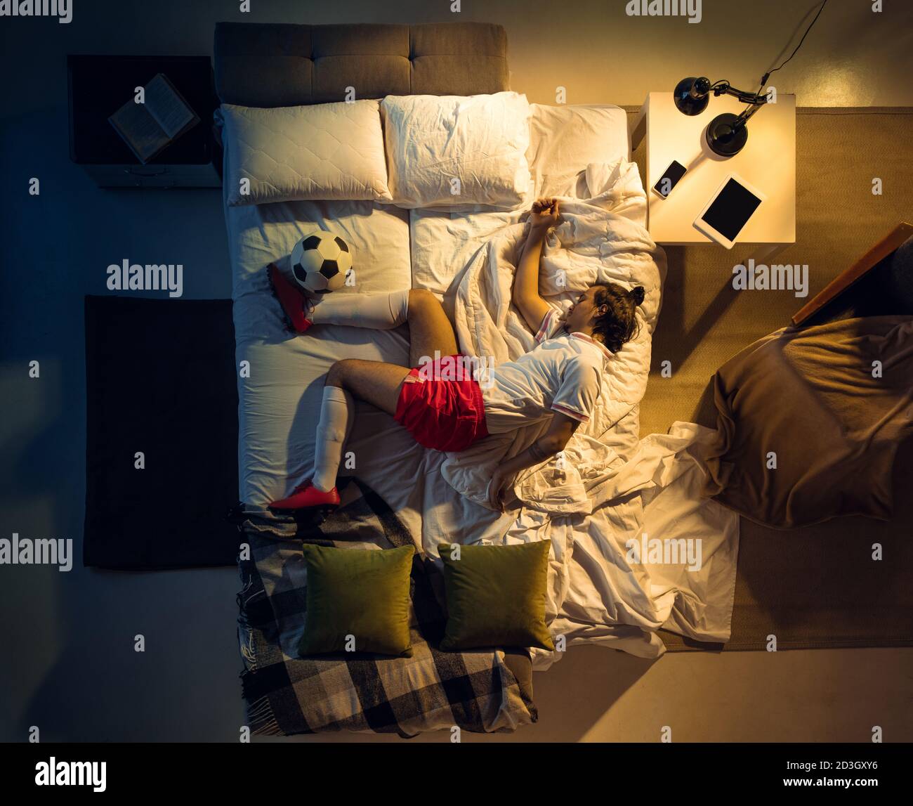 Winner. Top view of young professional football, soccer player sleeping ...