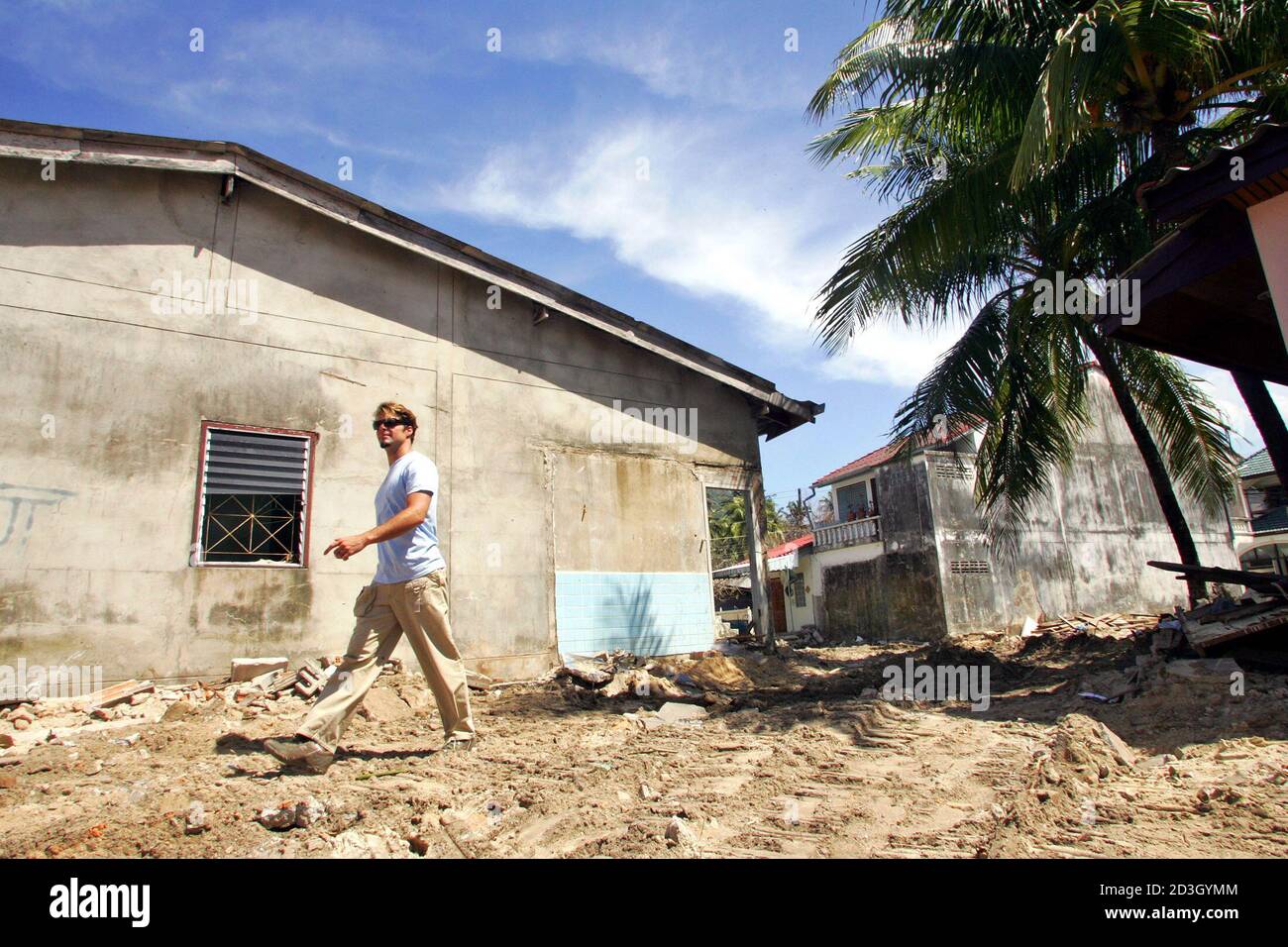 Puerto Rican singer Ricky Martin walks through debris left after ...