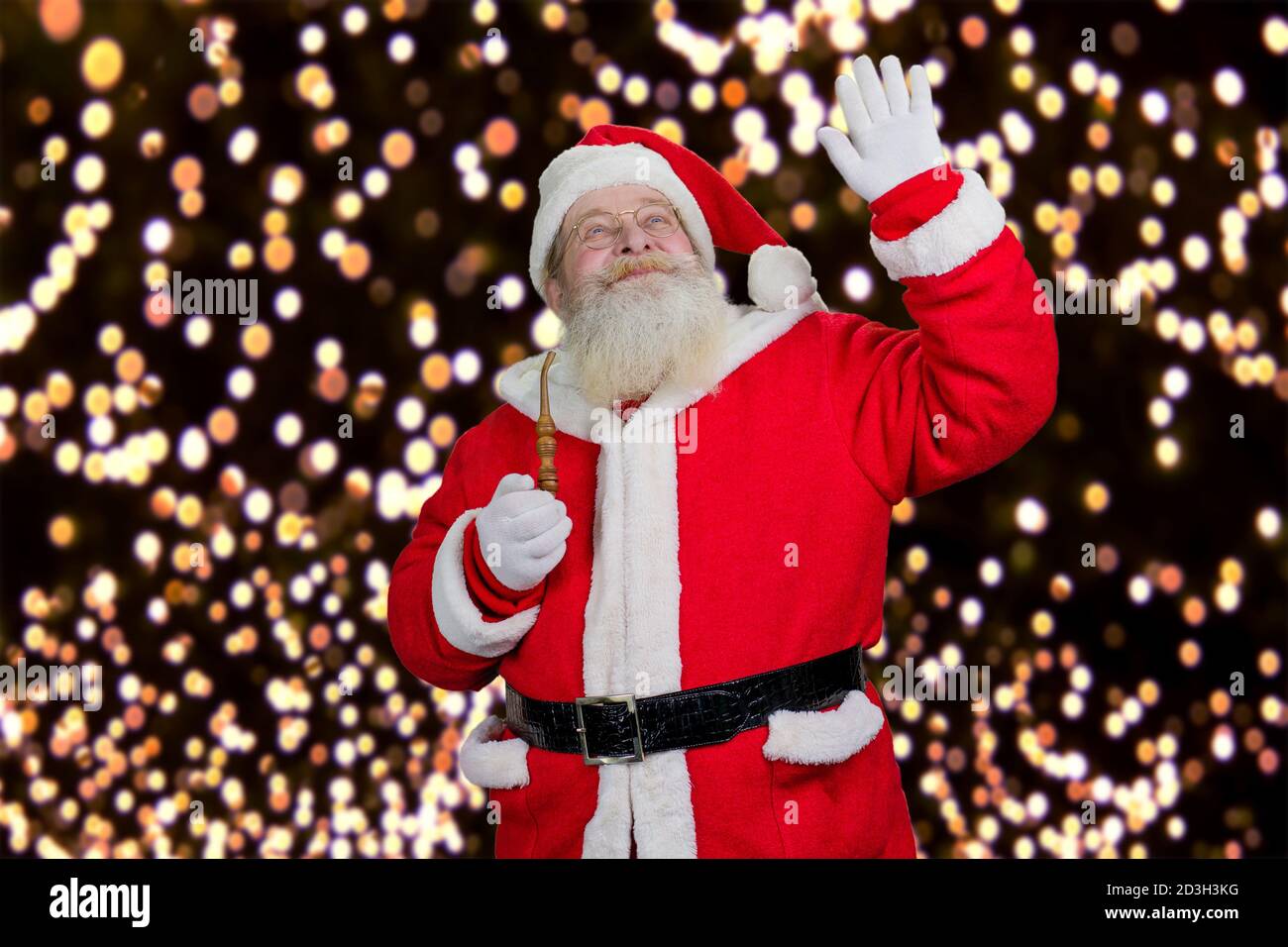 Santa waving with hand on lights background Stock Photo - Alamy