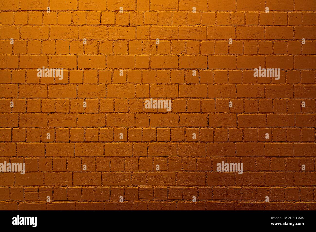 Orange brick wall background with shades of light and dark orange Stock ...