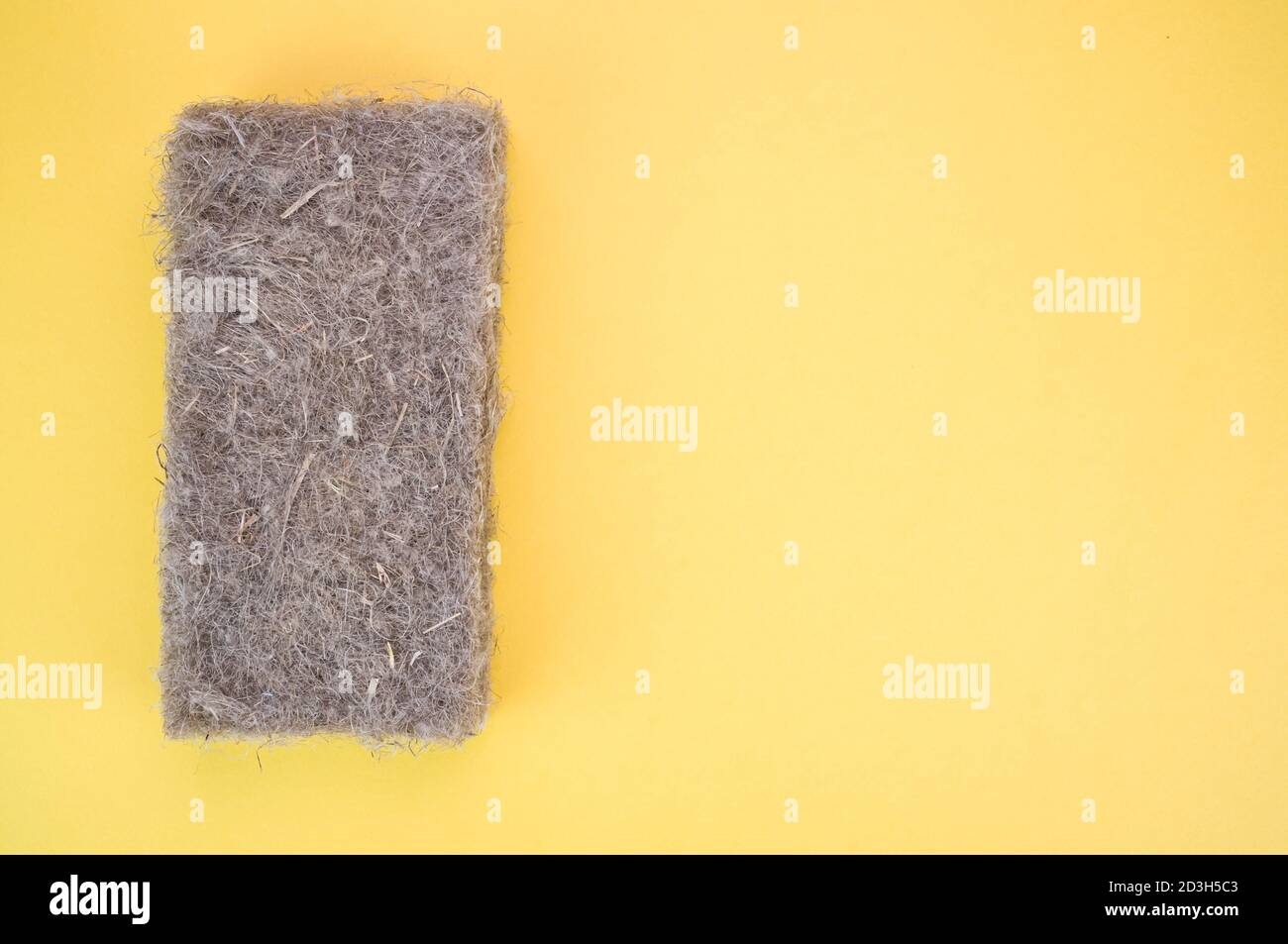 Abstract shot of a thermal fiber insulation panel on a yellow surface ...