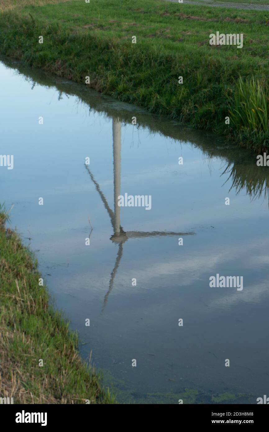 Wind Turbine reflected in drainage ditch. East Frisia. Germany Stock ...