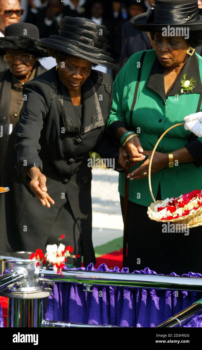 Albertina Sisulu L Accompanied By Adelaide Tambo R Casts Flowers Into The Grave Of Her albertina-sisulu-l-accompanied-by-adelaide-tambo-r-casts-flowers-into-the-grave-of-her