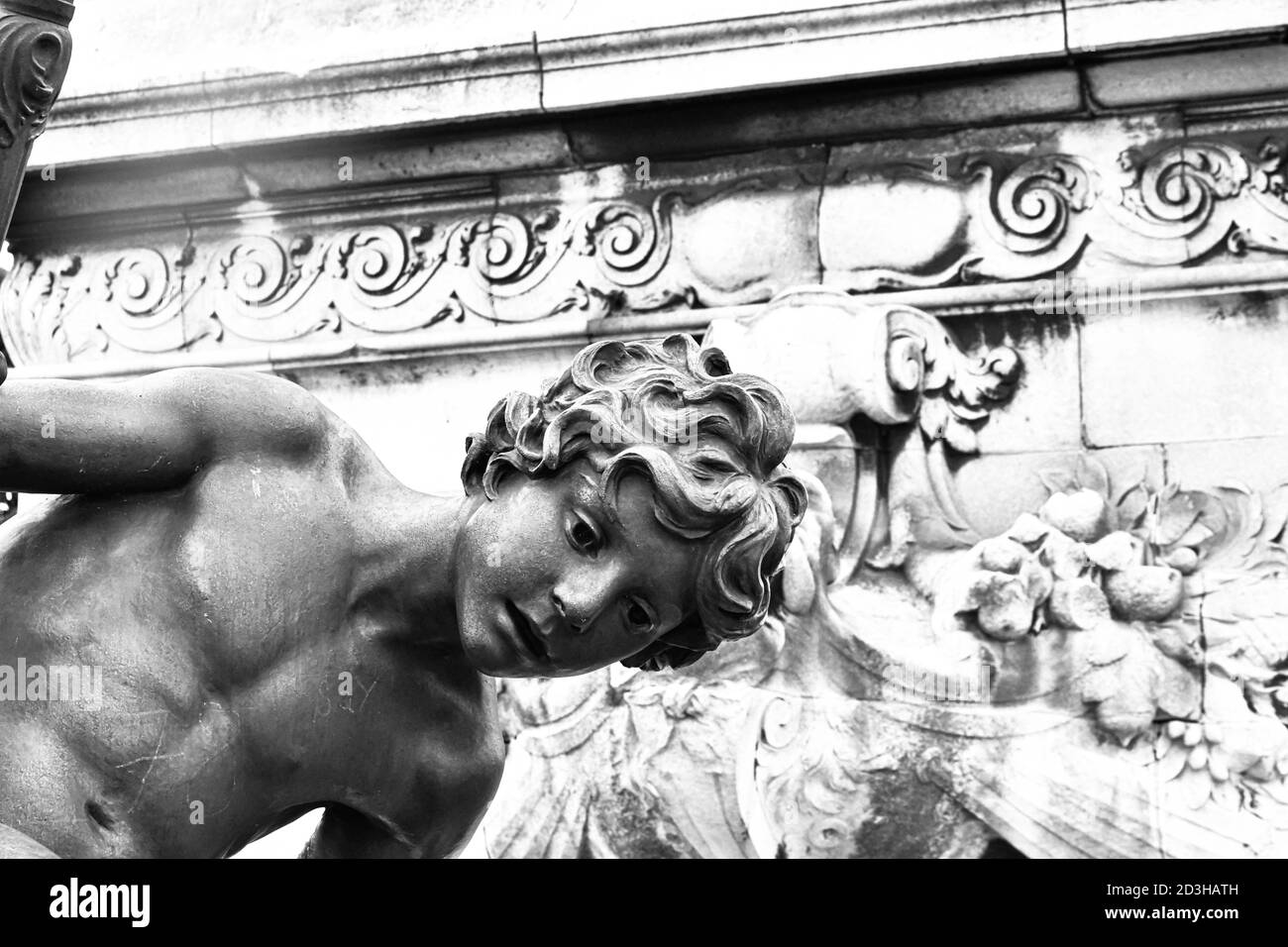 Grayscale shot of a sculpture of a baby boy on the Alexander III Bridge ...