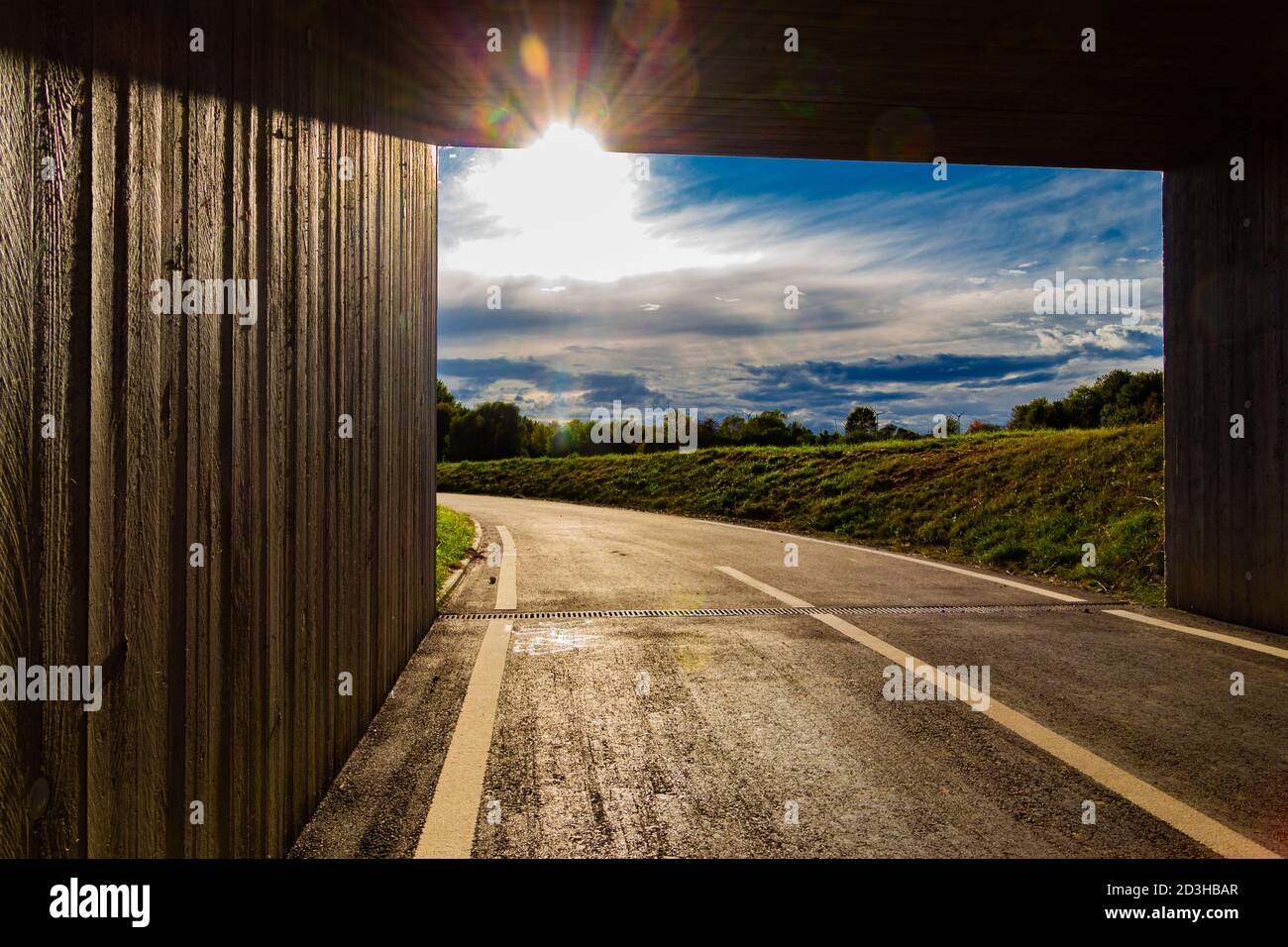 Sun shining through the end of a square tunnel Stock Photo - Alamy
