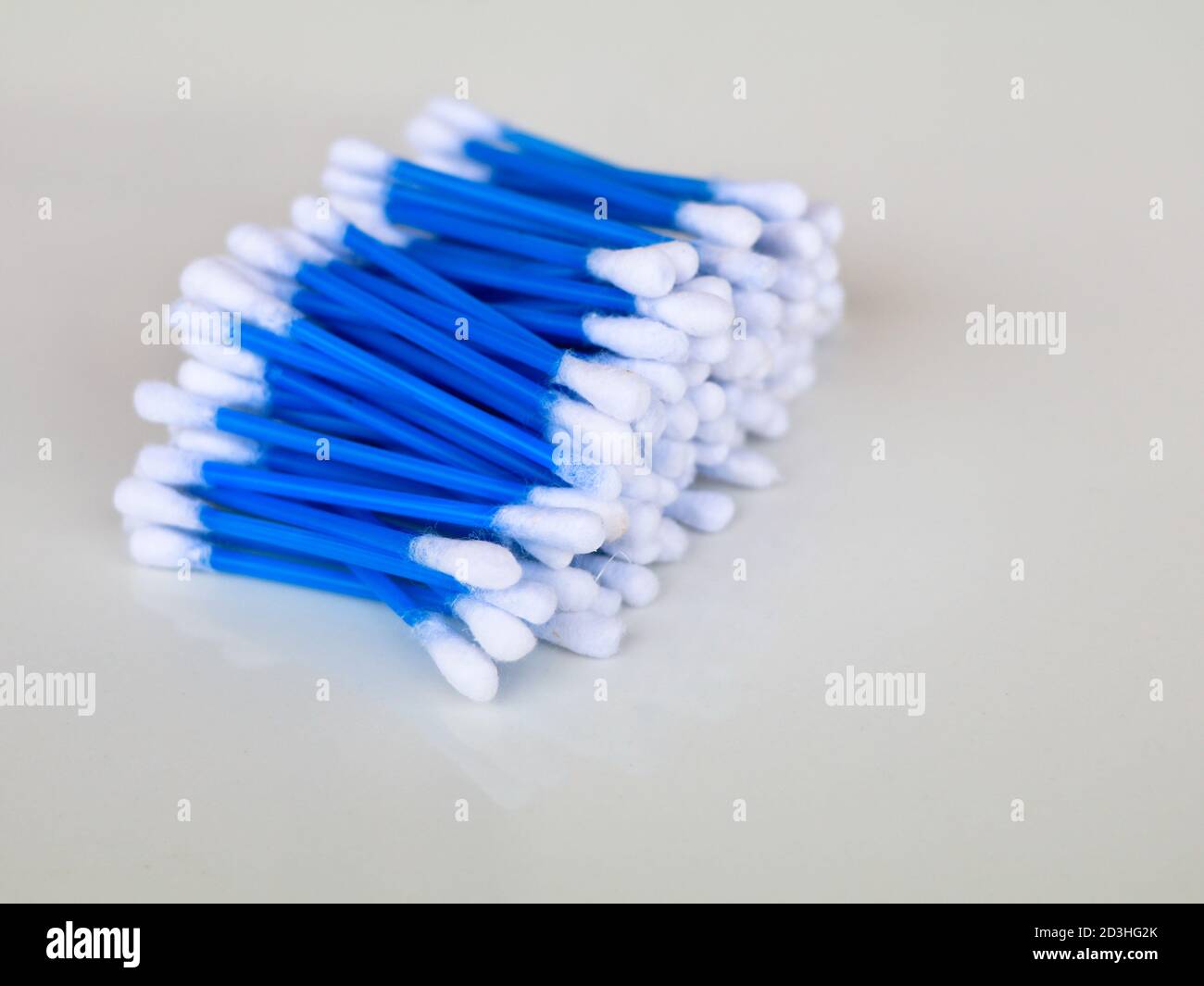 Blue color ear cleaning buds in packets, against white background ...