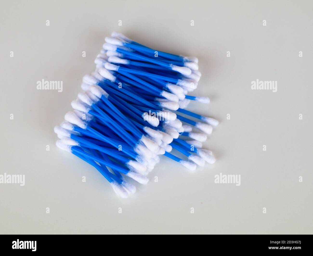 Blue color ear cleaning buds in packets, against white background ...