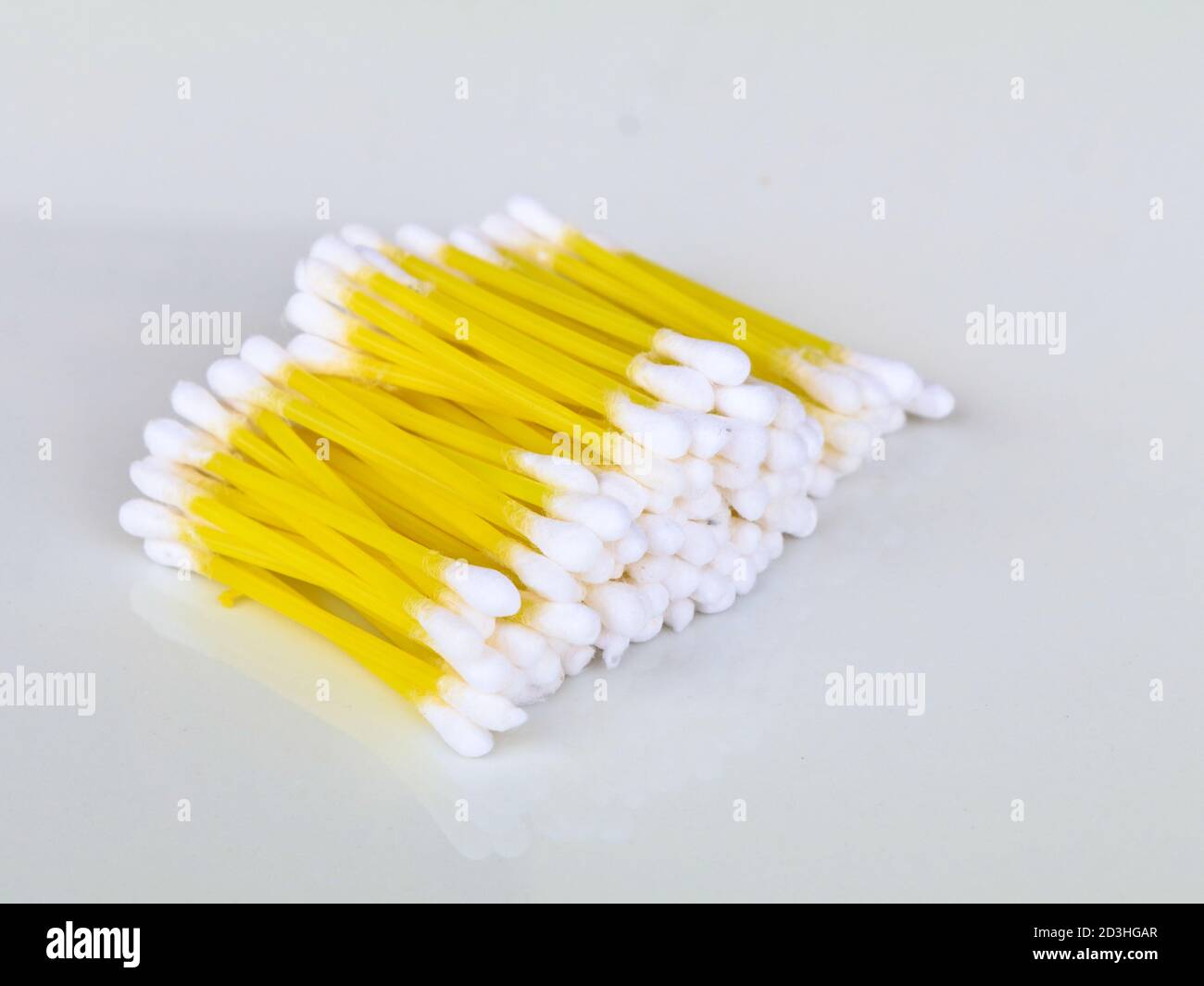 Yellow color ear cleaning buds in packets, against white background ...