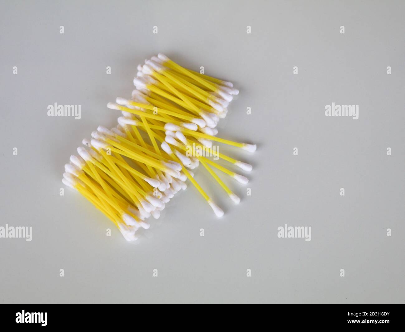 Yellow color ear cleaning buds in packets, against white background ...