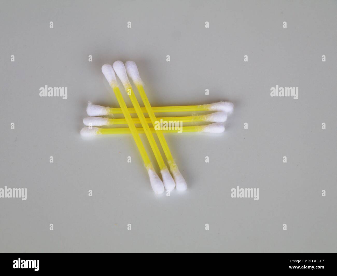 Yellow color ear cleaning buds in packets, against white background ...