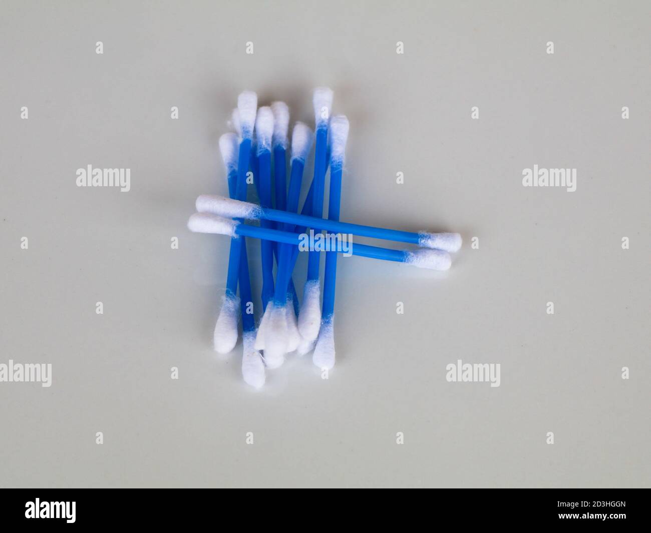 Blue color ear cleaning buds in packets, against white background ...