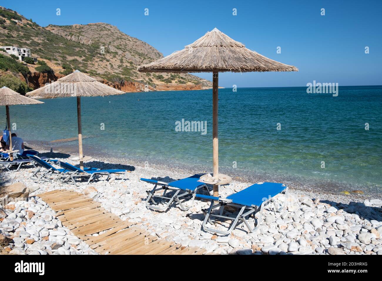 Plaka Lassithi with is traditional blue table and chairs and the beach ...