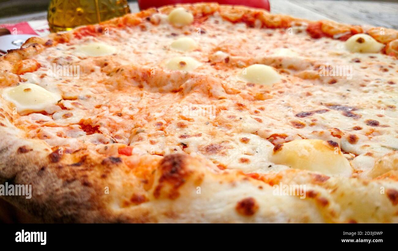 whole margherita pizza on a wooden table Stock Photo - Alamy