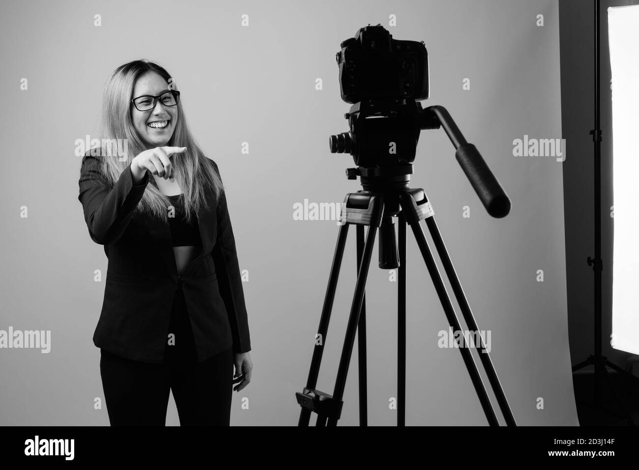 Portrait of happy young Asian businesswoman vlogging with camera Stock ...
