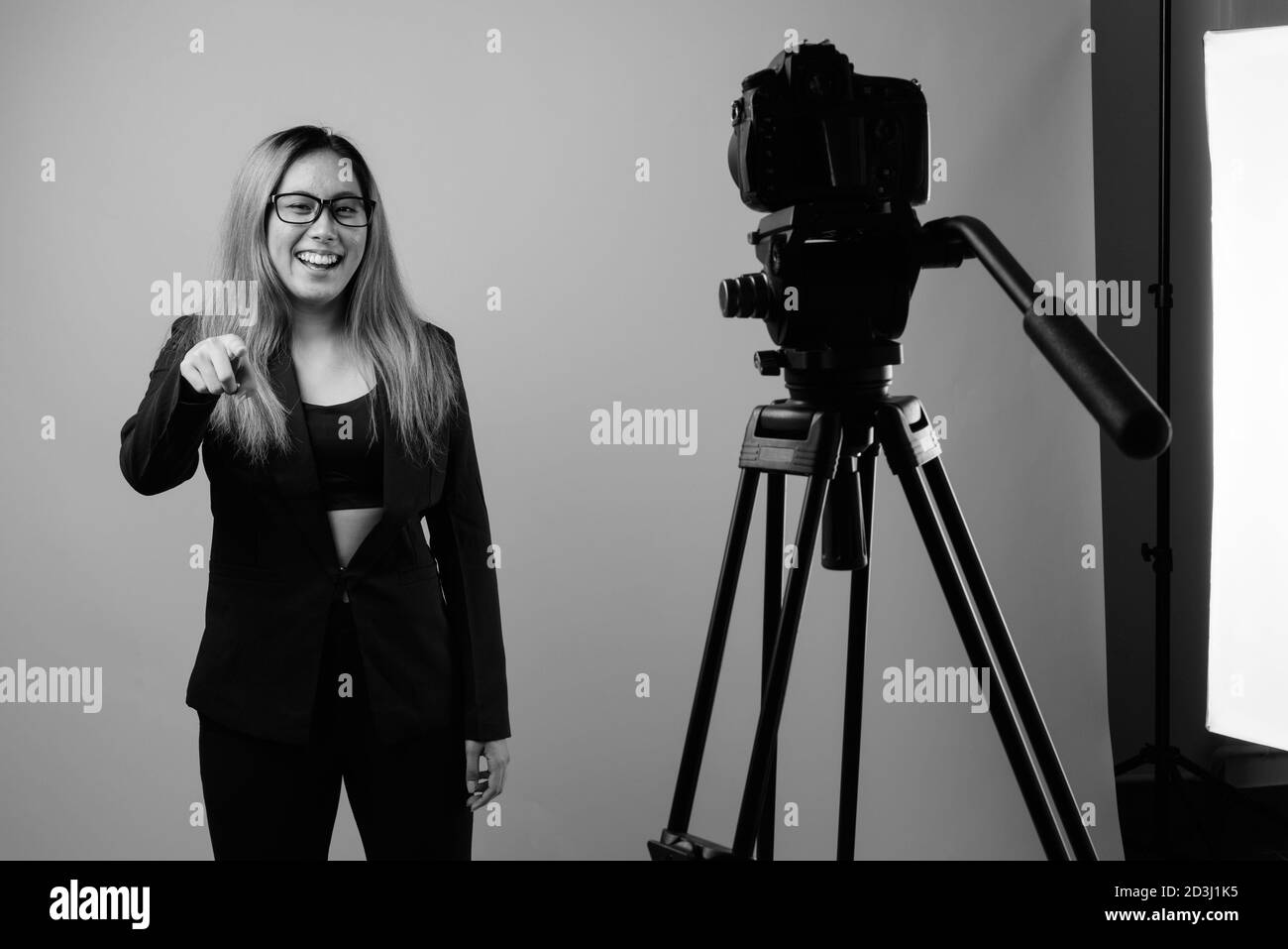 Portrait of happy young Asian businesswoman vlogging with camera Stock ...