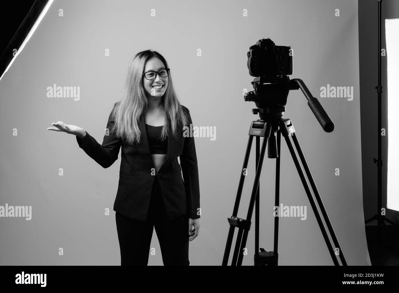 Portrait of happy young Asian businesswoman vlogging with camera Stock ...