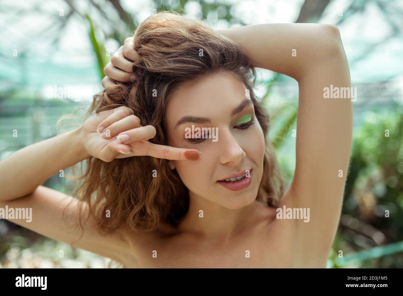 Pretty young woman showing one finger with eyeshadows on it Stock Photo ...
