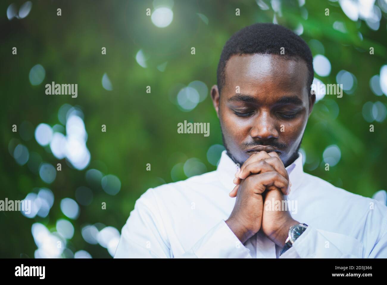 African man praying for thank god in the green nature Stock Photo - Alamy