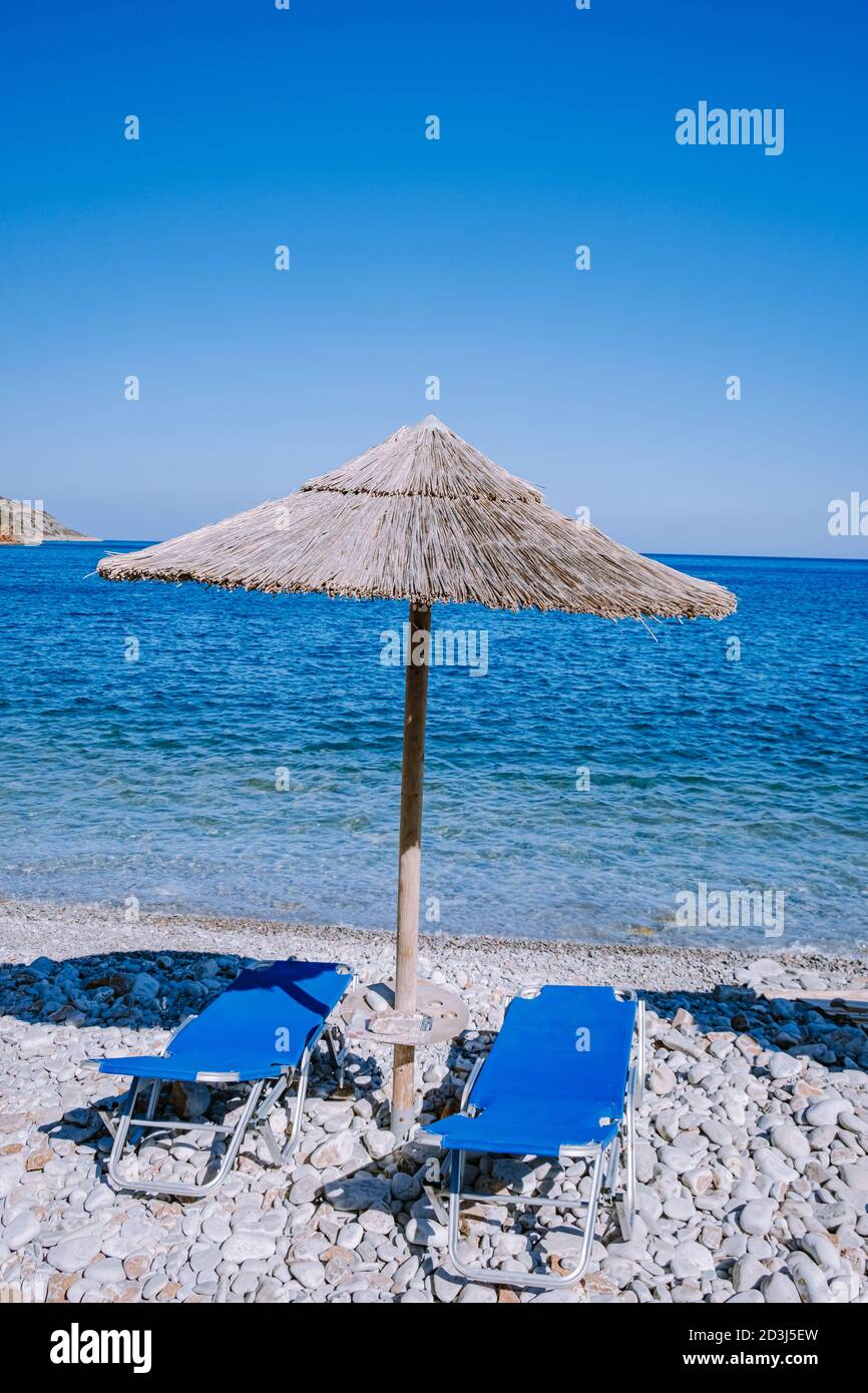 Plaka Lassithi with is traditional blue table and chairs and the beach ...