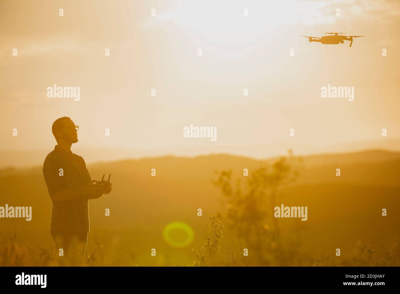 Drone operator man piloting a Drone In A Rural Setting Stock Photo - Alamy