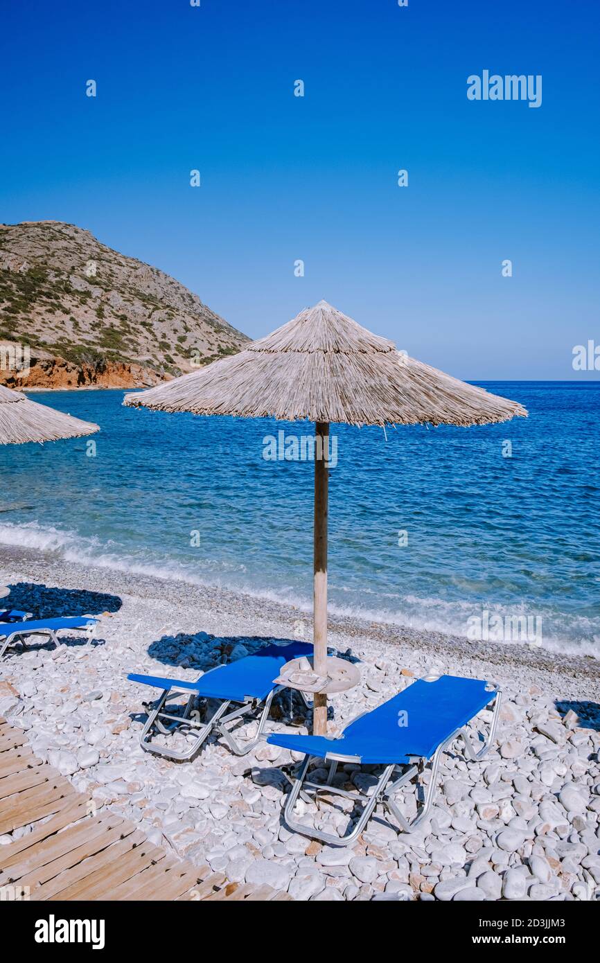 Plaka Lassithi with is traditional blue table and chairs and the beach ...