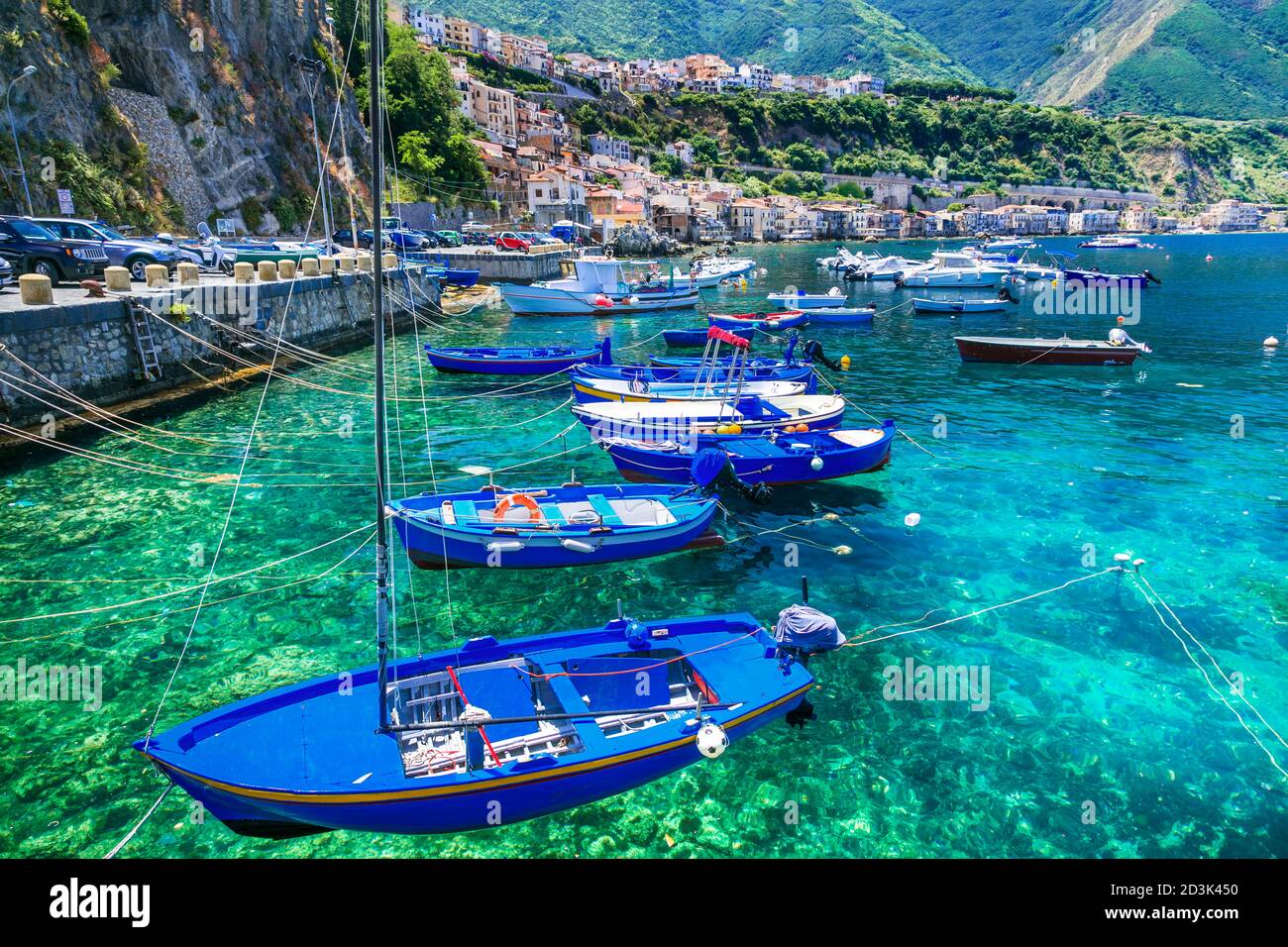 Colorful fishing boats and transparent emerald sea of Calabria. Schilla ...