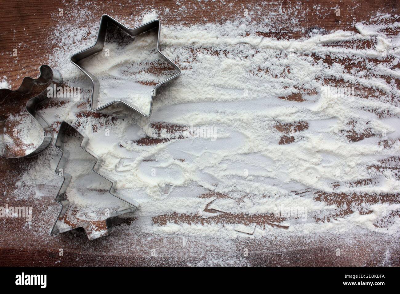Reindeer, christmas tree and star gingerbread cookie cutters and flour ...