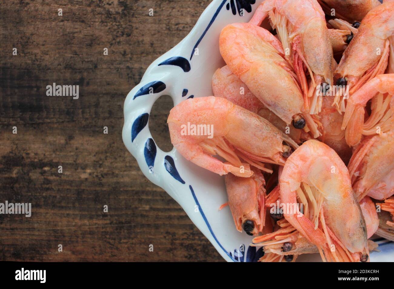 Cooked pink shrimps in the dish. Shell-on North Atlantic prawns in the ...