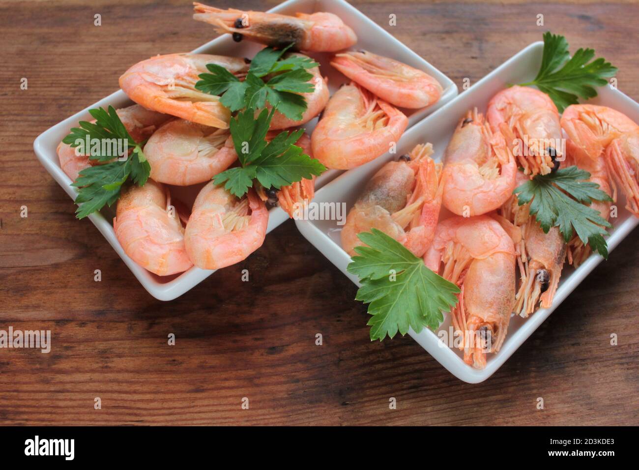 Cooked pink shrimps in the dish served with parsley. Shell-on North ...