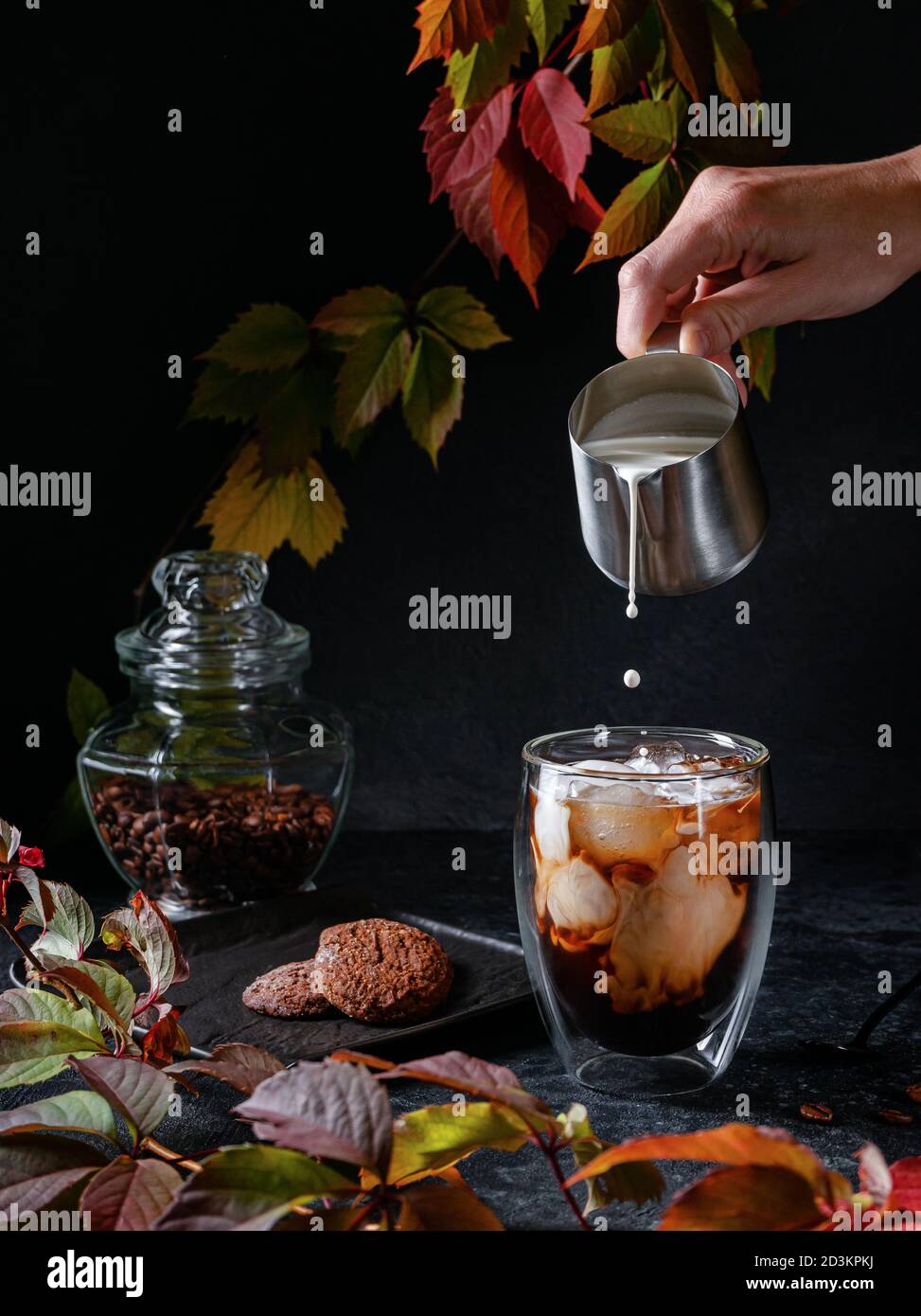Iced coffee with cream on autumn leaves background Stock Photo - Alamy